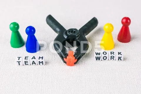 Team work concept - Figures form with clamp tool as symbol for a ...