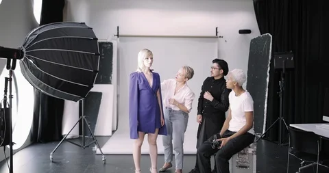 Team working behind the scenes of a phot... | Stock Video | Pond5