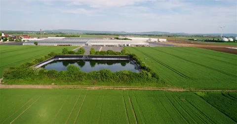 Technical reservoir next to large greenh... | Stock Video | Pond5