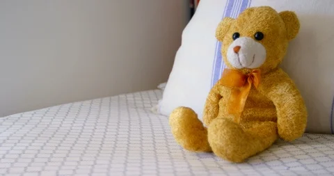 Teddy bear on bed in bedroom at home 4k | Stock Video | Pond5