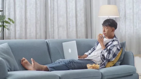 Teen Boy Eating Snacks And Typing On A L... | Stock Video | Pond5