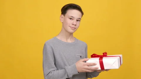 Teen Boy Giving Wrapped Gift Box To Came... | Stock Video | Pond5