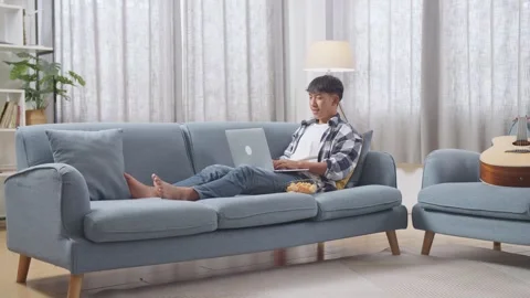 Teen Boy With Snacks Typing On A Laptop ... | Stock Video | Pond5