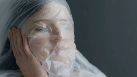A teen girl breathes through polyethylen... | Stock Video | Pond5