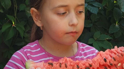 Teen girl eats a sweet, juicy watermelon... | Stock Video | Pond5