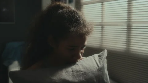 Teen Girl Hugging Pillow and Crying on B... | Stock Video | Pond5