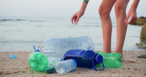 Teen Girl is Picking up Plastic Trash on... | Stock Video | Pond5