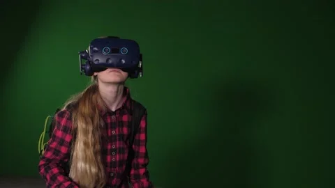 A teen girl in a VR headset immersed in ... | Stock Video | Pond5