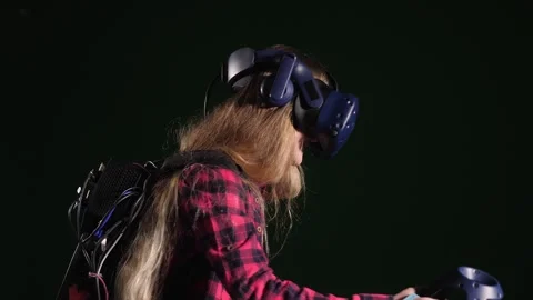 A teen girl in a VR headset immersed in ... | Stock Video | Pond5