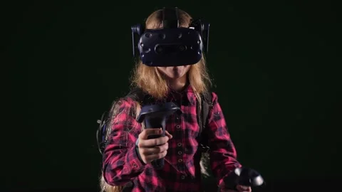 A teen girl in a VR headset immersed in ... | Stock Video | Pond5