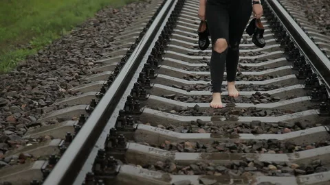 teen girl walking barefoot on a train | Stock Video | Pond5