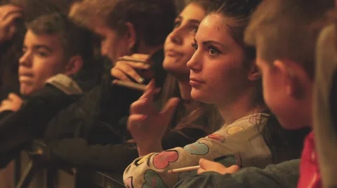 Teen girls smoking cigarettes in a crowd... | Stock Video | Pond5