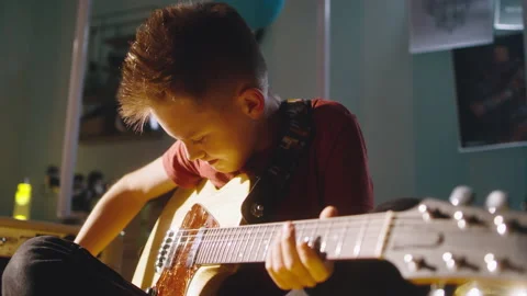 Teen rocker playing guitar during rehear... | Stock Video | Pond5