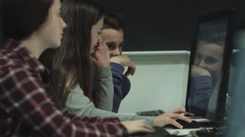 Teenage boy and girls working on compute... | Stock Video | Pond5