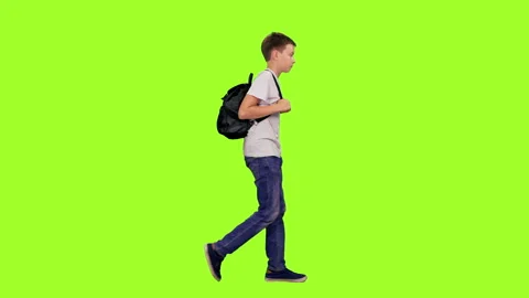 Teenage boy with backpack walking on gre... | Stock Video | Pond5