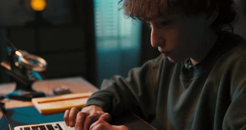 Teenage boy doing homework using compute... | Stock Video | Pond5