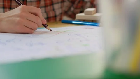 Teenage Boy Drawing on Paper | Stock Video | Pond5