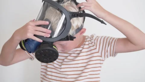 A teenage boy learns to put on a gas mas... | Stock Video | Pond5
