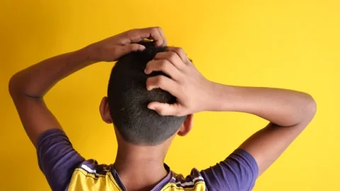 teenage boy Scratching Head Against blac... | Stock Video | Pond5