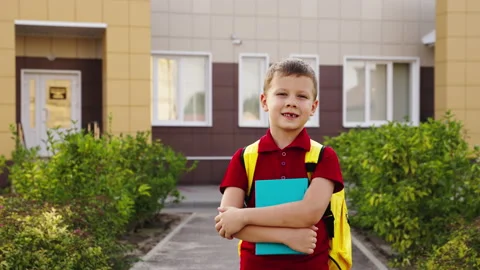 teenage boy with textbook his hands smil... | Stock Video | Pond5