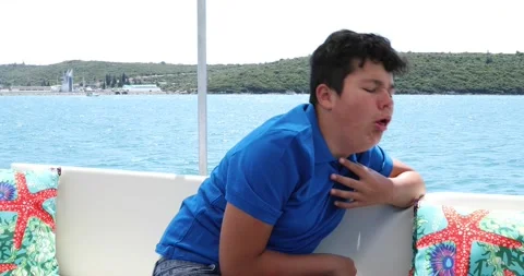 Teenage boy vomiting during the boat tra... | Stock Video | Pond5