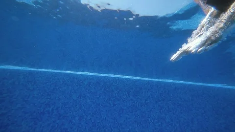 A teenage girl dive in blue swimming poo... | Stock Video | Pond5