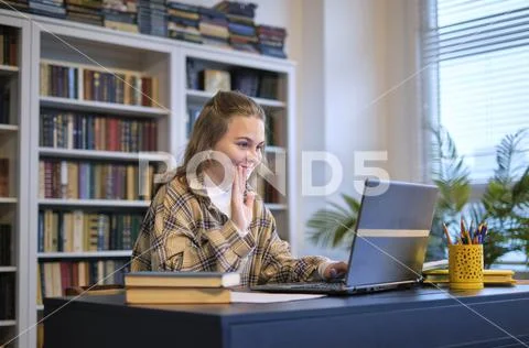 Teenage girl doing homework at a desk in her bedroom. teen girl school ...