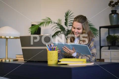 Teenage girl doing homework at a desk in her bedroom. teen girl school ...