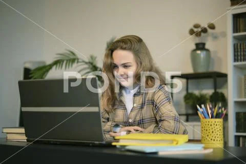 Teenage girl doing homework at a desk in her bedroom. teen girl school ...