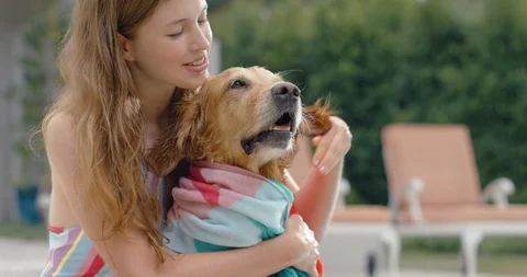teenage girl drying wet dog with towel a... | Stock Video | Pond5