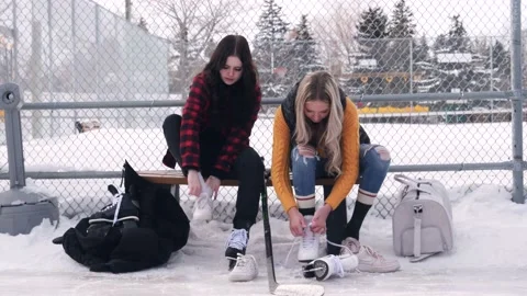 Teenage girl friends taking off ice skat... | Stock Video | Pond5