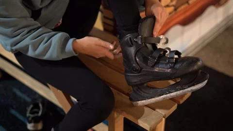 Teenage girl taking an ice skate off her... | Stock Video | Pond5