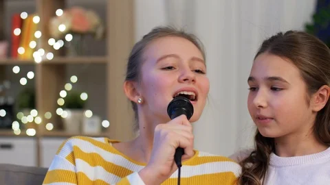 teenage girls with microphone singing at... | Stock Video | Pond5