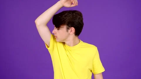 Teenager boy smelling armpit with nasty ... | Stock Video | Pond5
