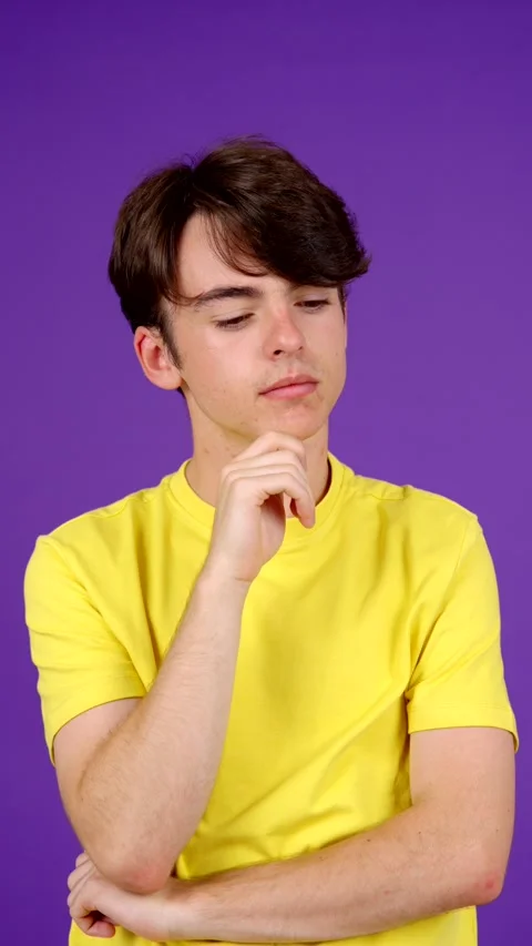 Teenager boy thinking isolated on purple... | Stock Video | Pond5