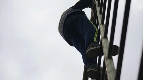 A teenager climbs the gym ladder in the ... | Stock Video | Pond5