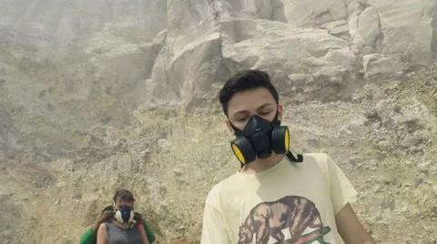 Teenager in gas mask walking down Ijen v... | Stock Video | Pond5