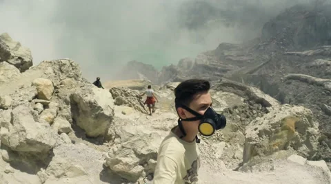 Teenager in gas mask walking down Ijen v... | Stock Video | Pond5