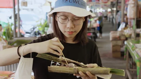 Teenager girl eating sticky rice | Stock Video | Pond5