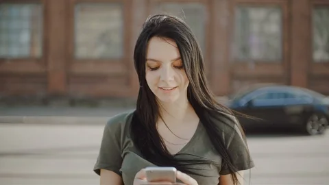 Teenager girl in a good mood types the m... | Stock Video | Pond5