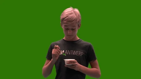 teenager model on green screen eating yo... | Stock Video | Pond5