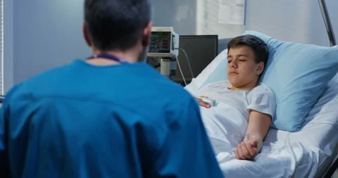 Teenager patient talking his doctor in h... | Stock Video | Pond5