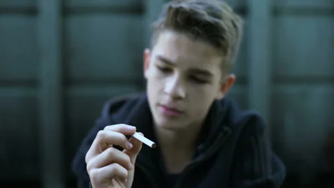 Teenager smoking cigarette, hiding from ... | Stock Video | Pond5