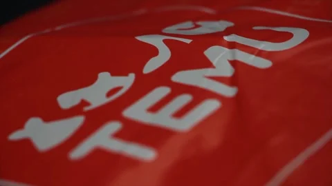 temu orange bag package with logo on it,... | Stock Video | Pond5