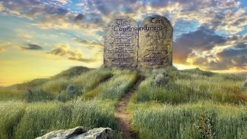 Ten Commandments on grassy hill at sunse... | Stock Video | Pond5