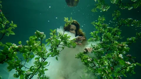 tender lady in white gown is floating in... | Stock Video | Pond5