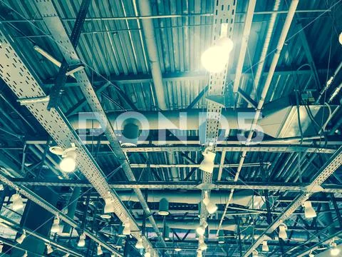 Texture of iron metal ceiling with tubes and lamps in the mall store ...