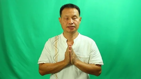 Thai man praying with green background | Stock Video | Pond5