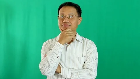 Thai man thinking on green background | Stock Video | Pond5