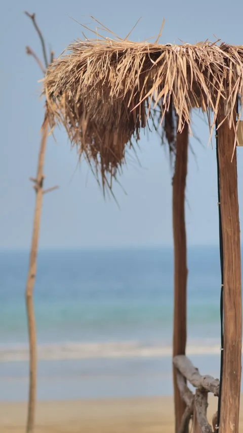 Thatched wooden huts sway in the wind by... | Stock Video | Pond5